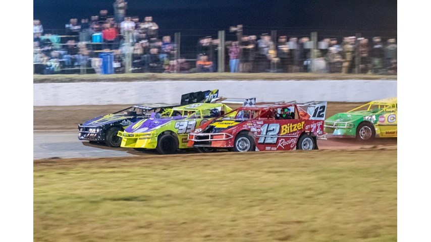 High-speed action at national oval racing spectacle | George Herald
