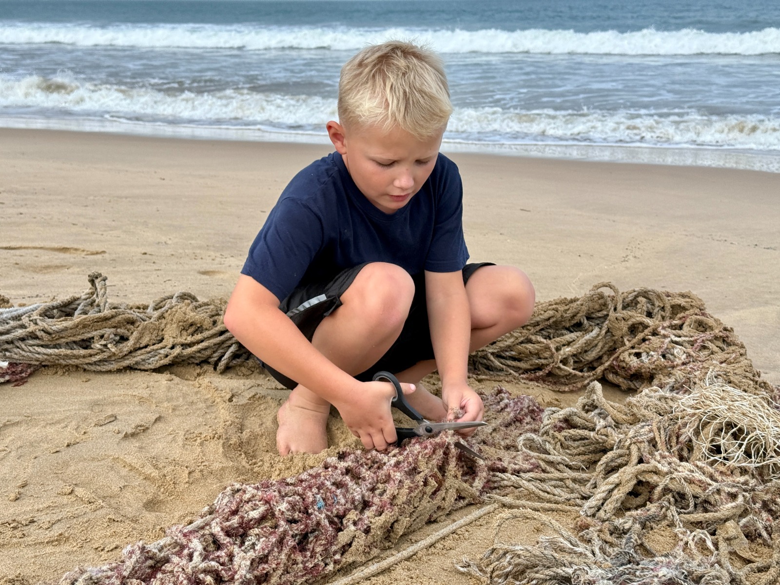 Father, son remove net from beach | Mossel Bay Advertiser